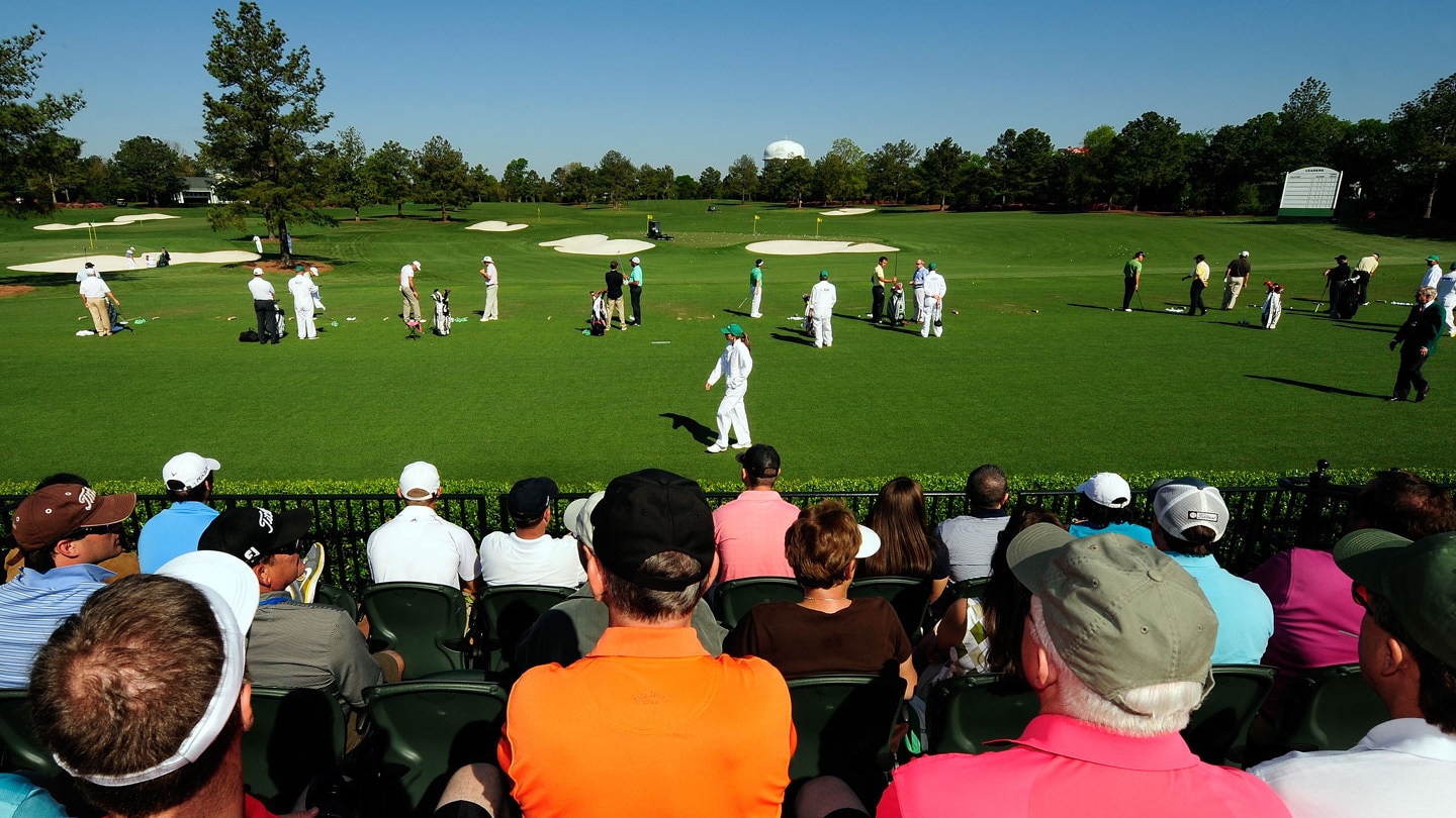 Masters participants use the practice facility in front of viewing ...
