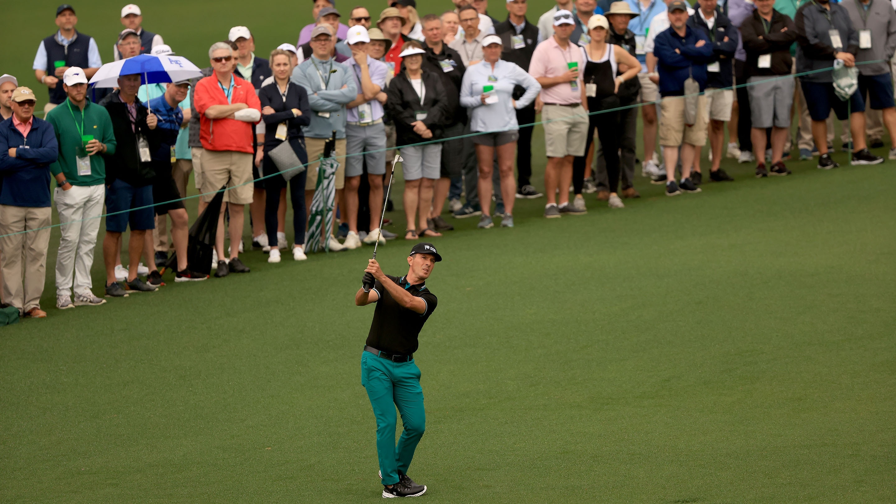 Masters patrons watch Masters champion Mike Weir of Canada chip to the ...