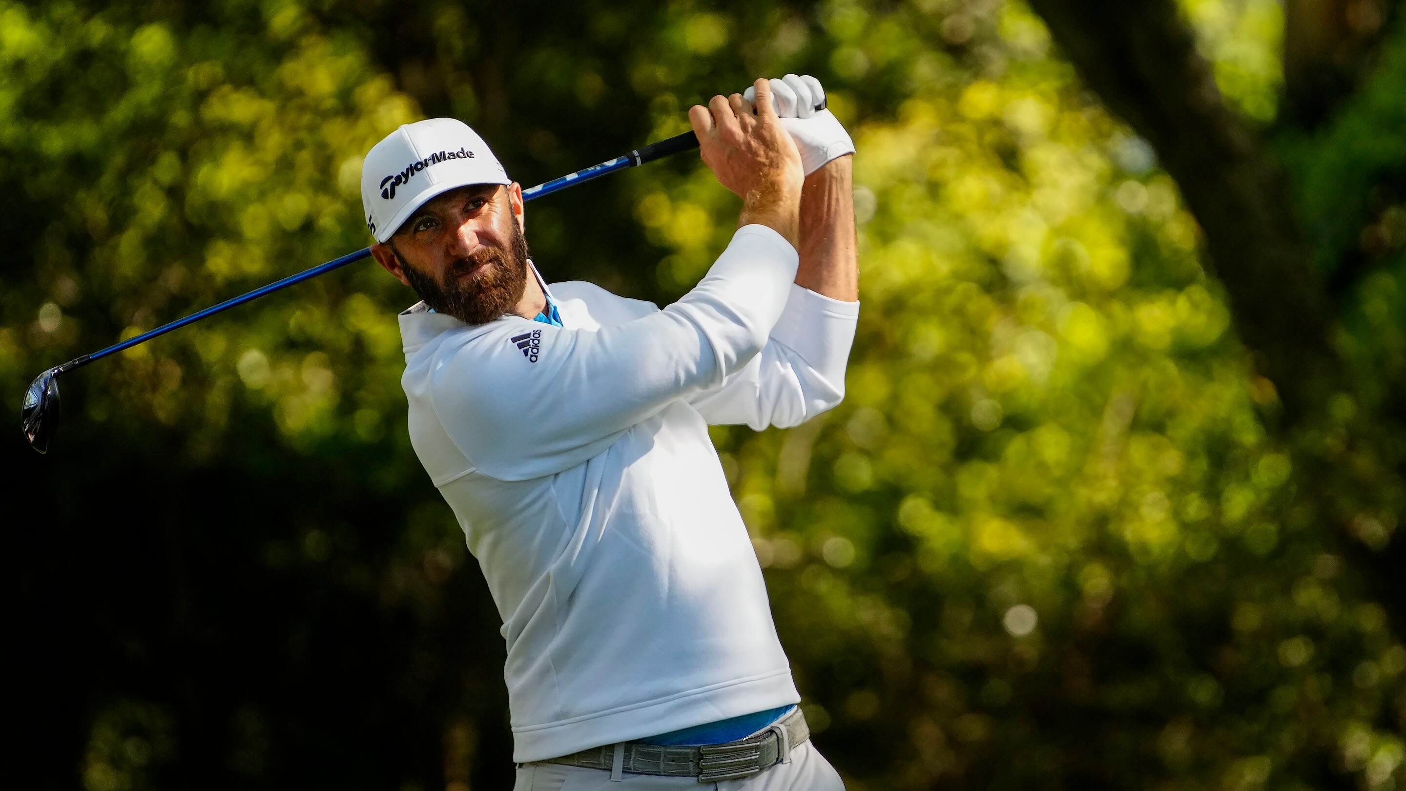 Masters champion Dustin Johnson plays a stroke from the No. 2 tee ...