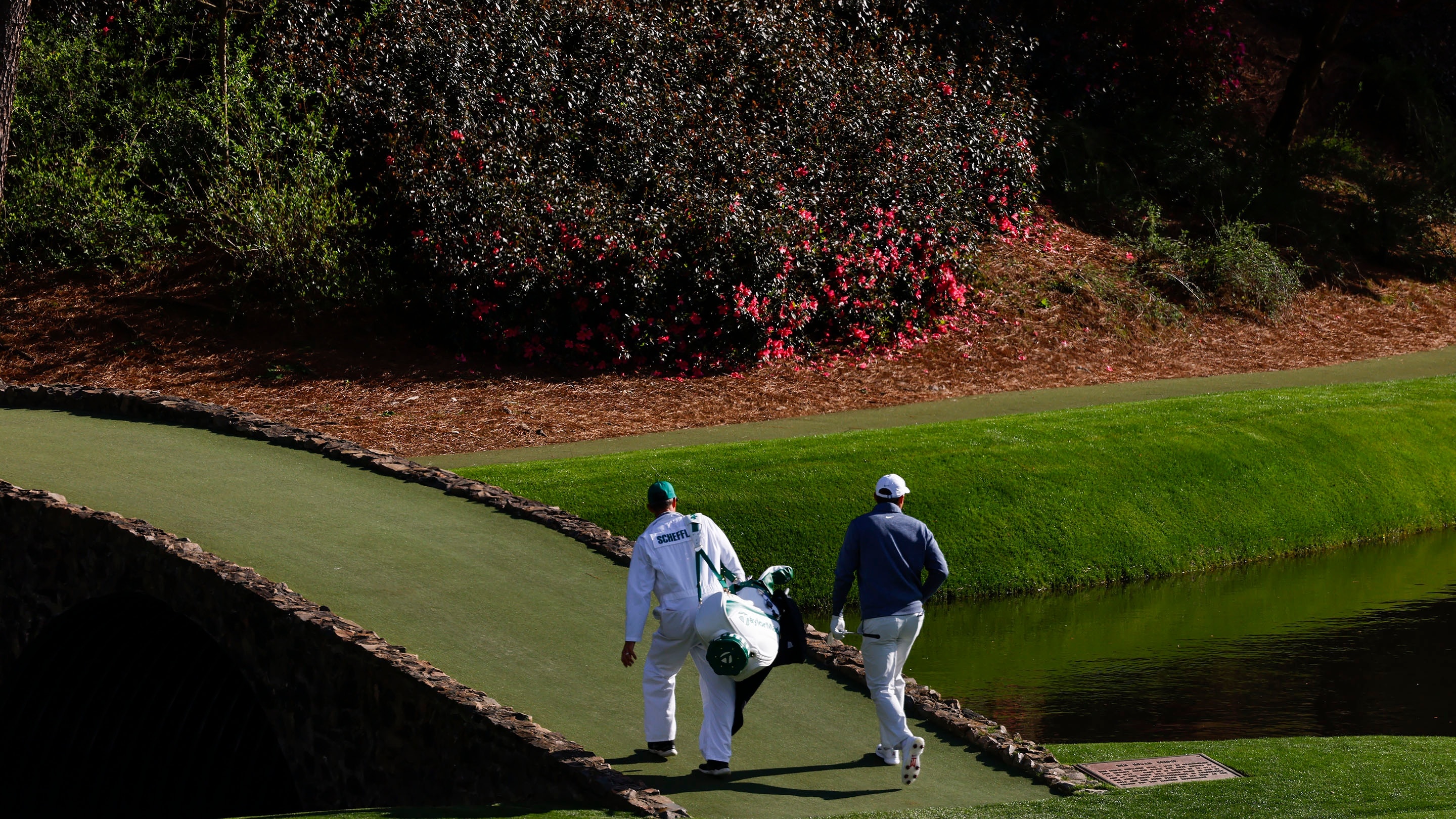Scottie Scheffler of South Africa cross the Hogan Bridge at No. 12 on ...